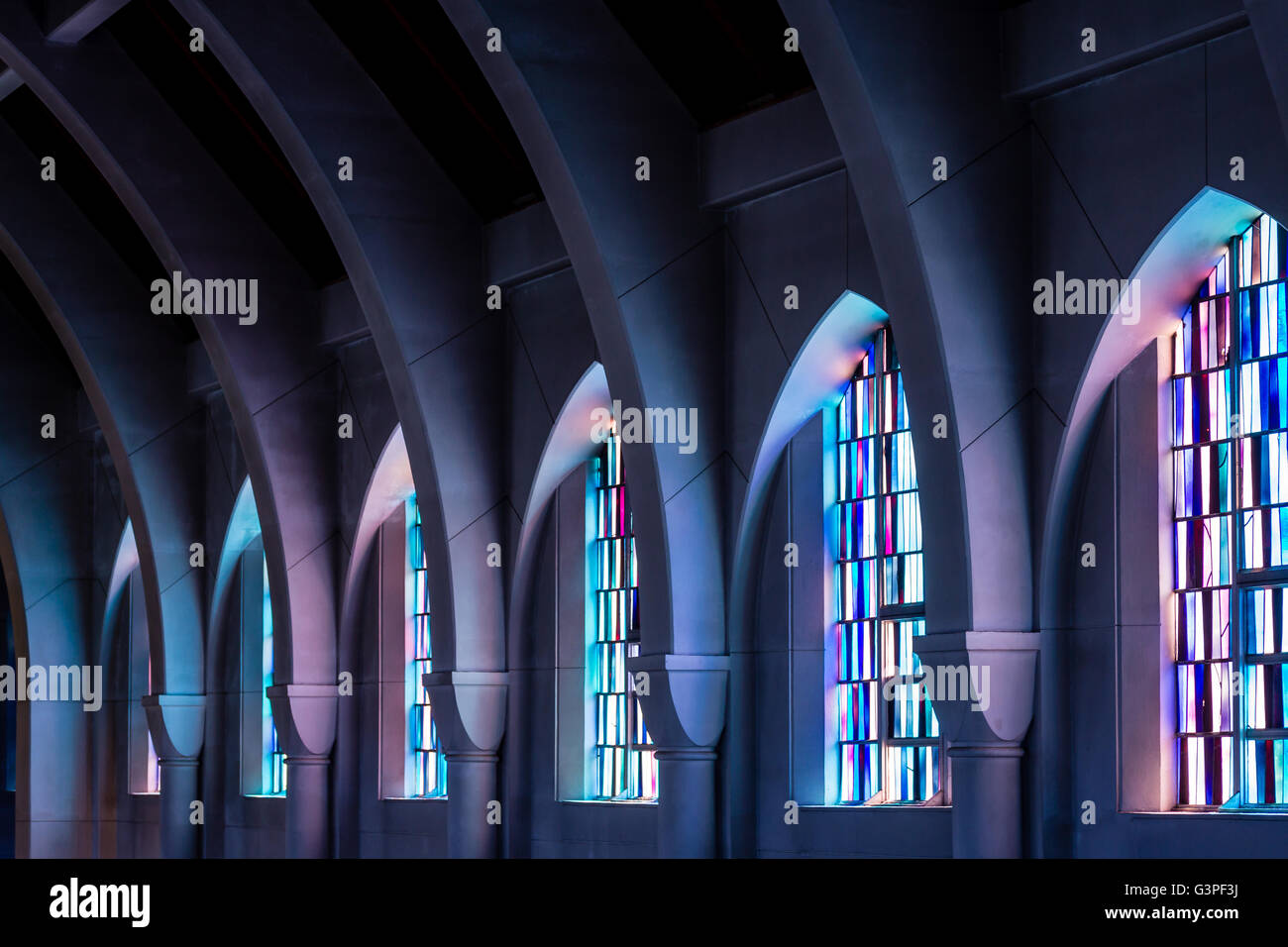 Arched columns in monastery chapel with stained glass windows Stock ...