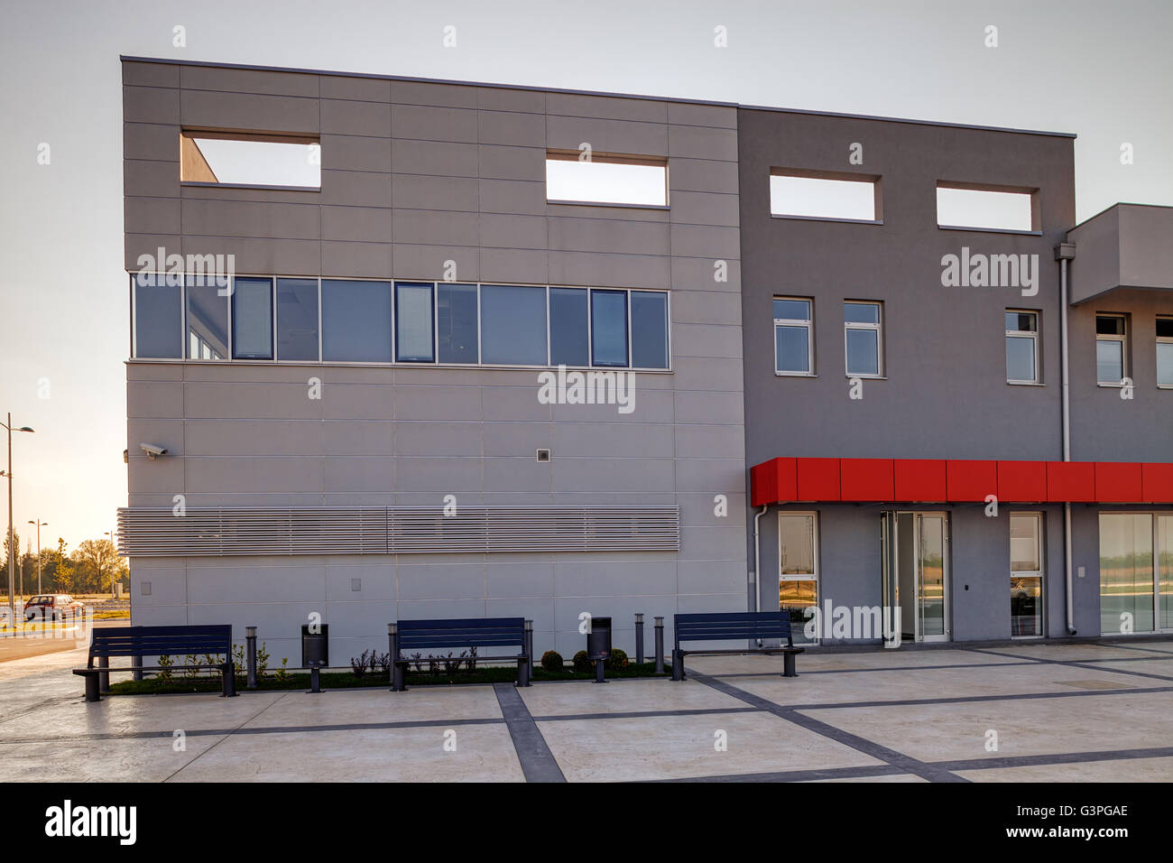 Details of gray and red facade on modern residential building made of ...