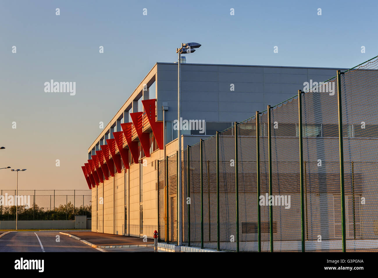 Details of gray and red facade on modern residential building made of ...