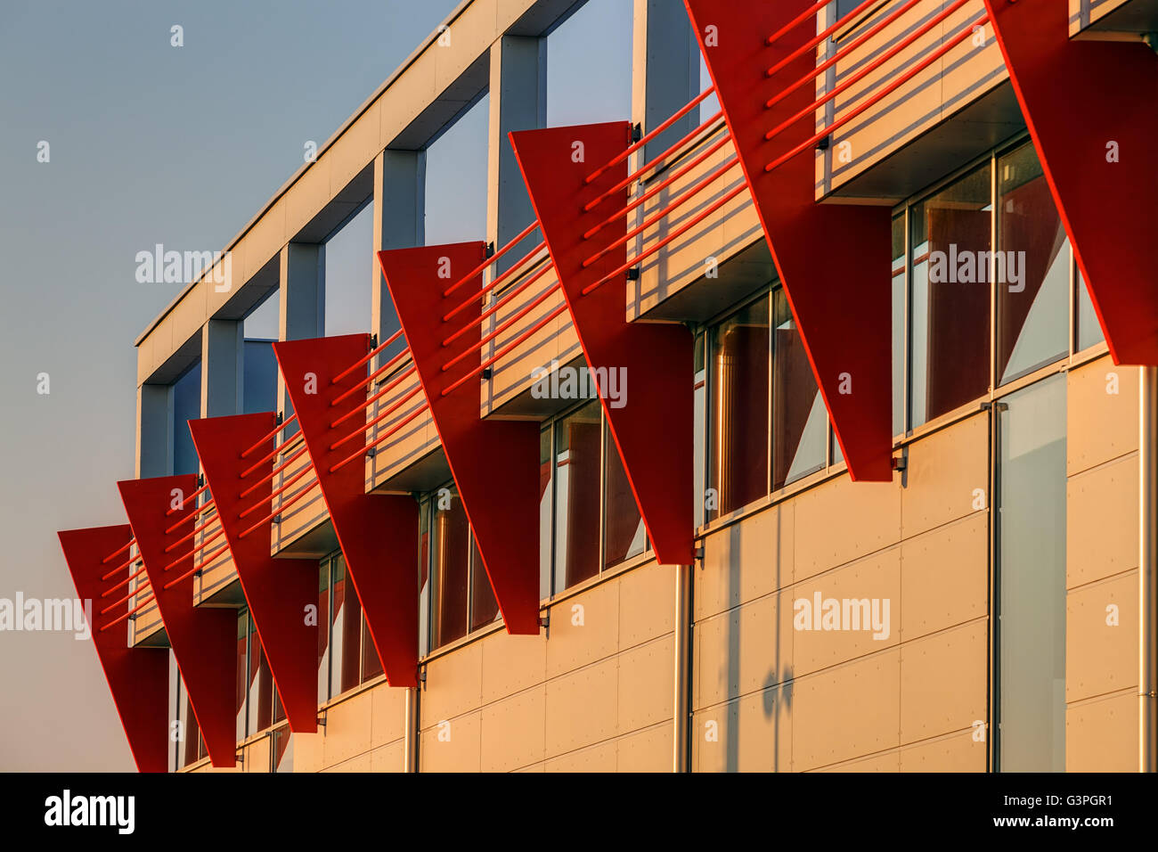 Details of gray and red facade on modern residential building made of ...