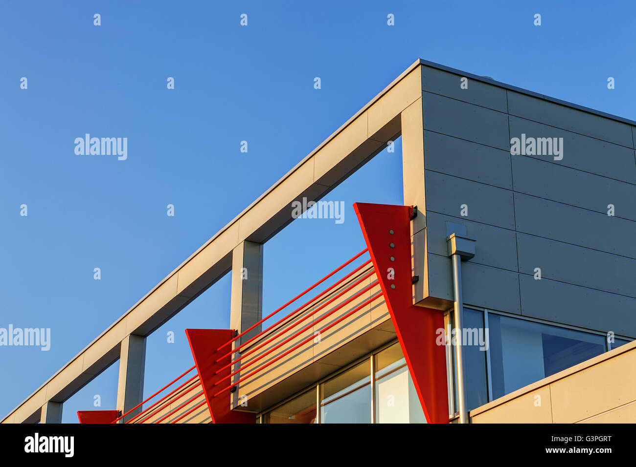 Details of gray and red facade on modern residential building made of ...