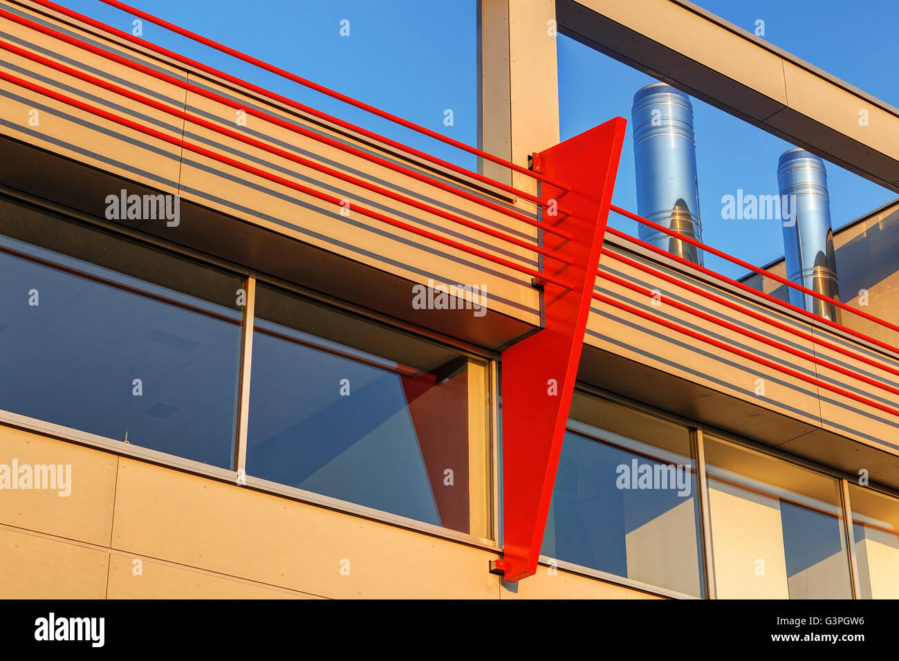 Details of gray and red facade on modern residential building made of ...