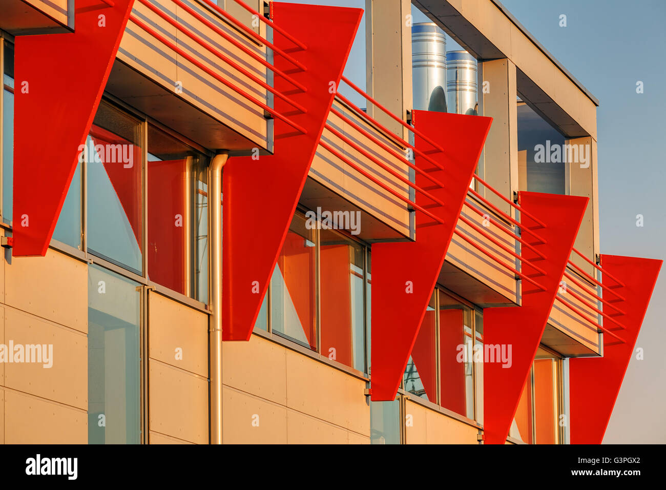 Details of gray and red facade on modern residential building made of ...
