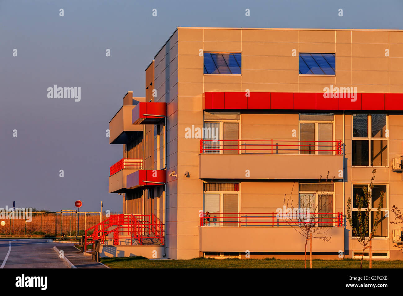 Details of gray and red facade on modern residential building made of ...