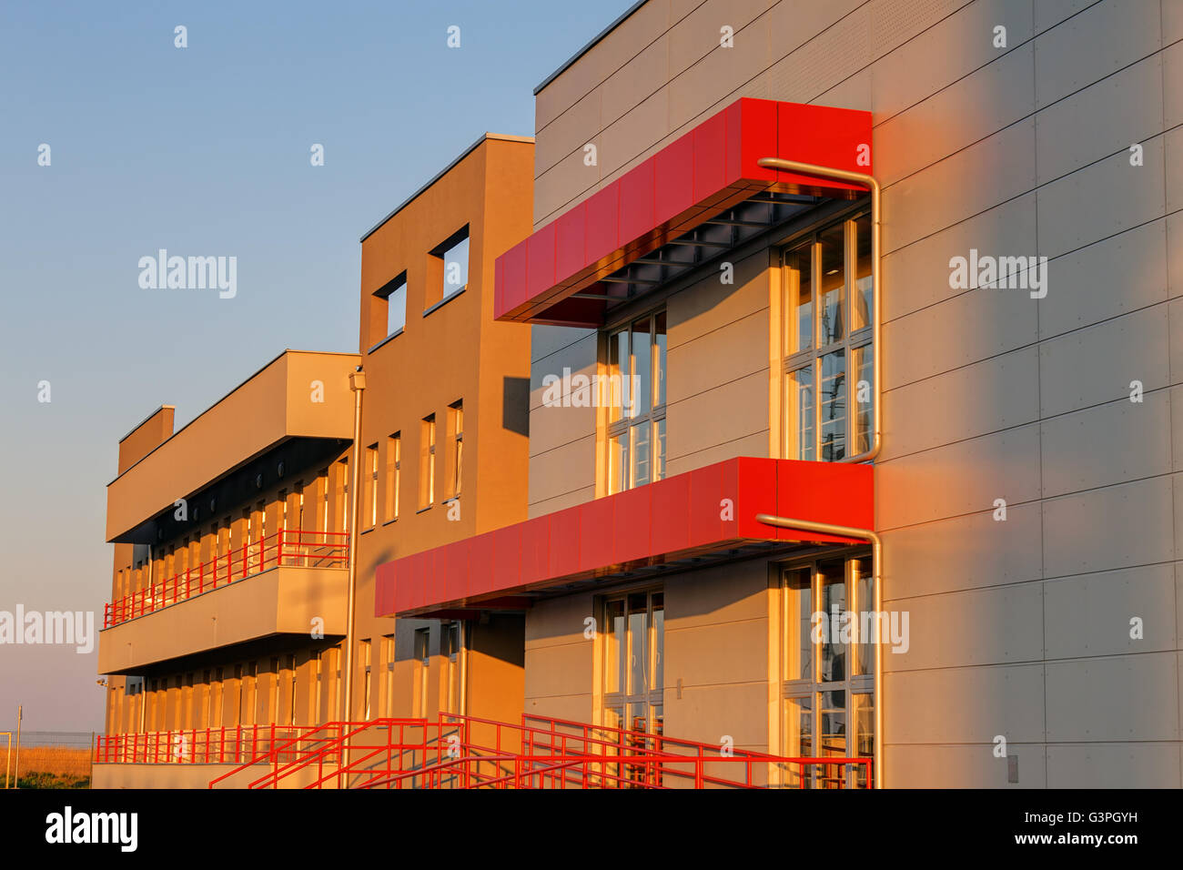 Details of gray and red facade on modern residential building made of ...