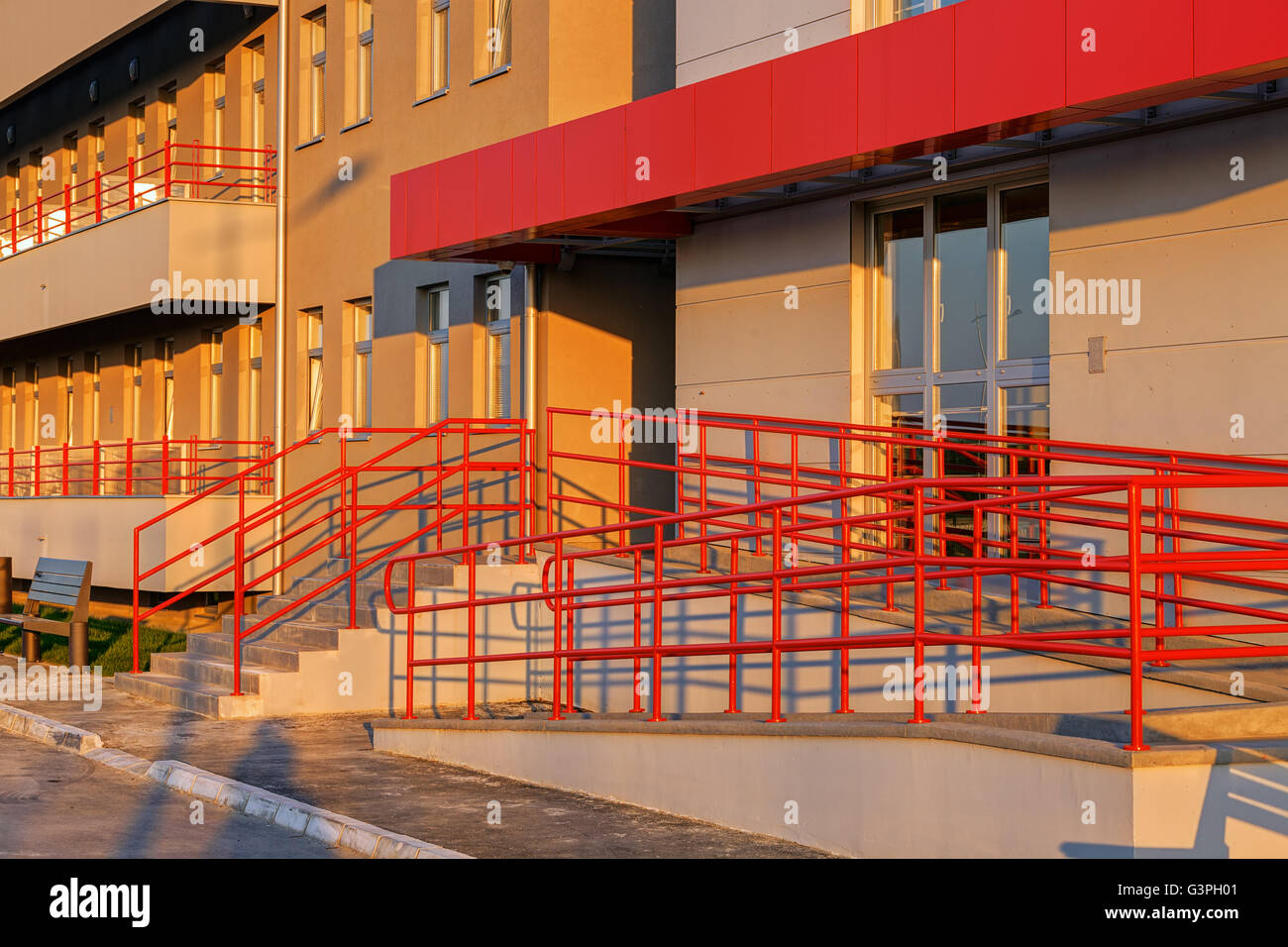 Details of gray and red facade on modern residential building made of ...