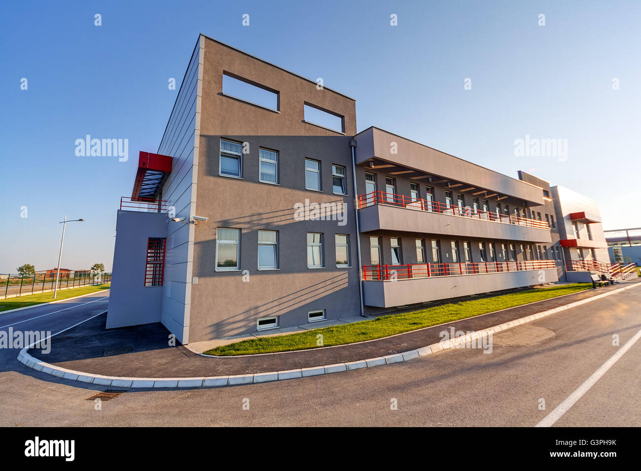 Details of gray and red facade on modern residential building made of ...