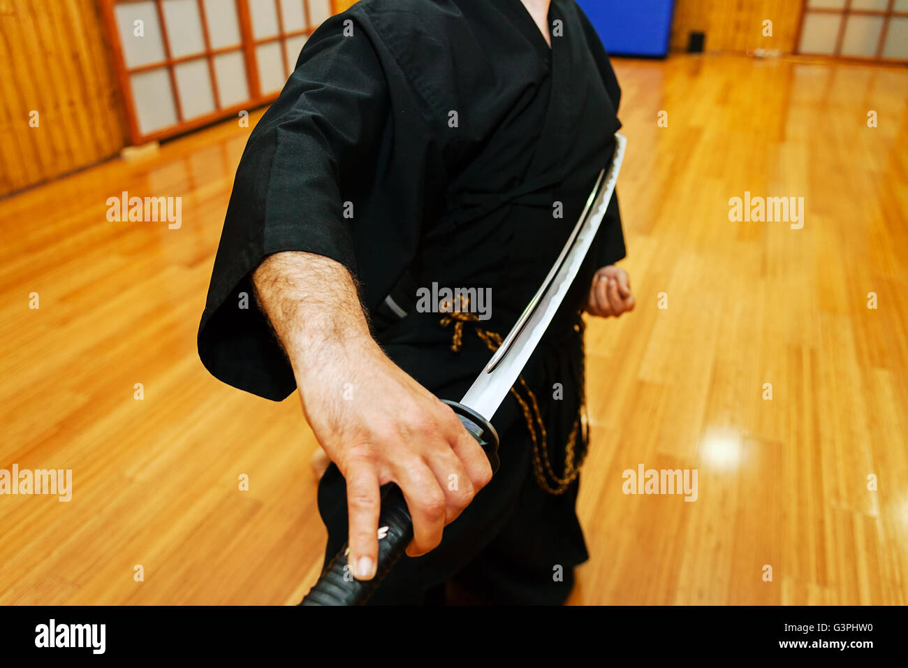 Detail of Japanese katana sword in hands of iaido fighter during ...