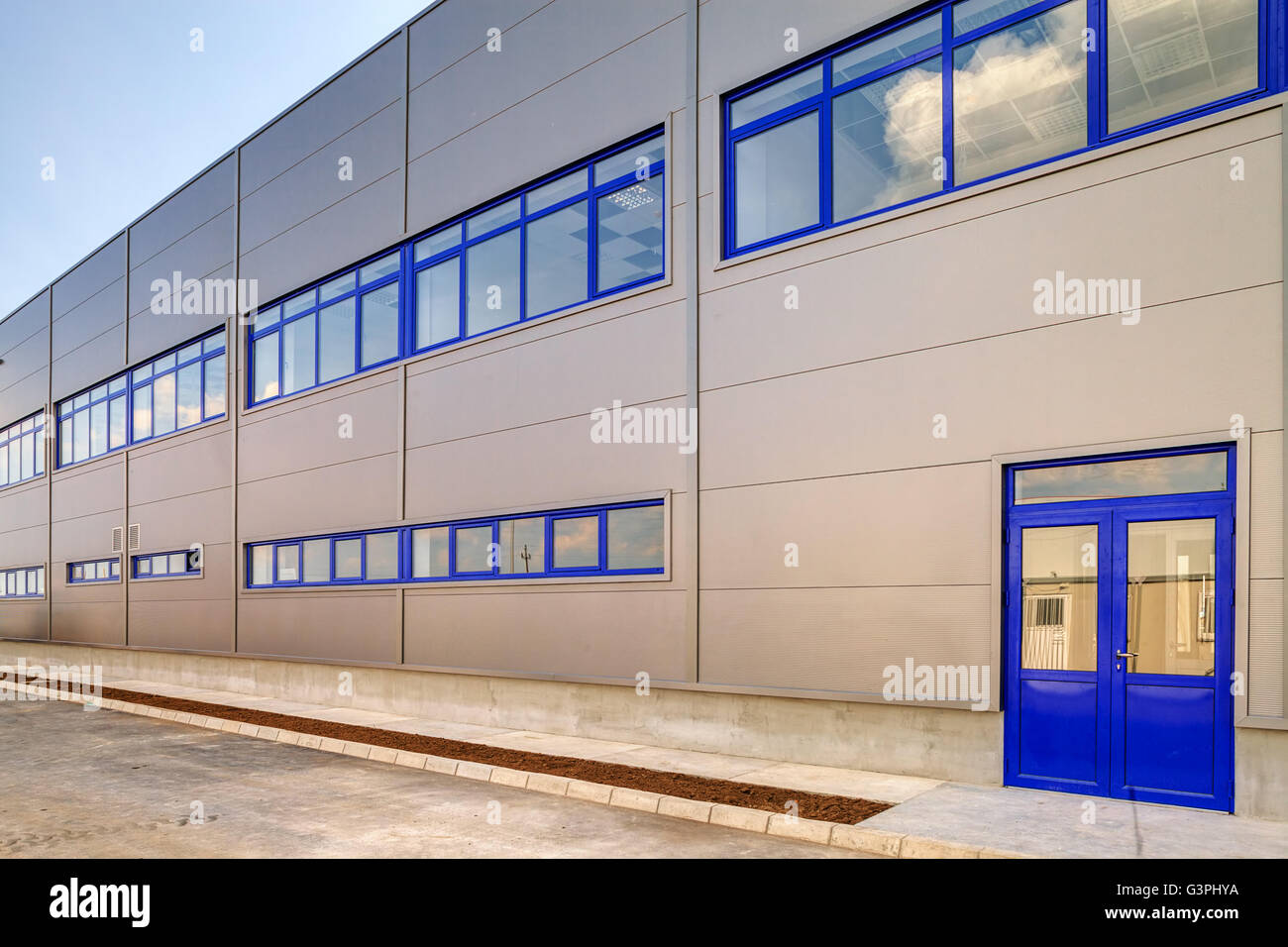 Details of blue facade with and aluminum panels on industrial building ...
