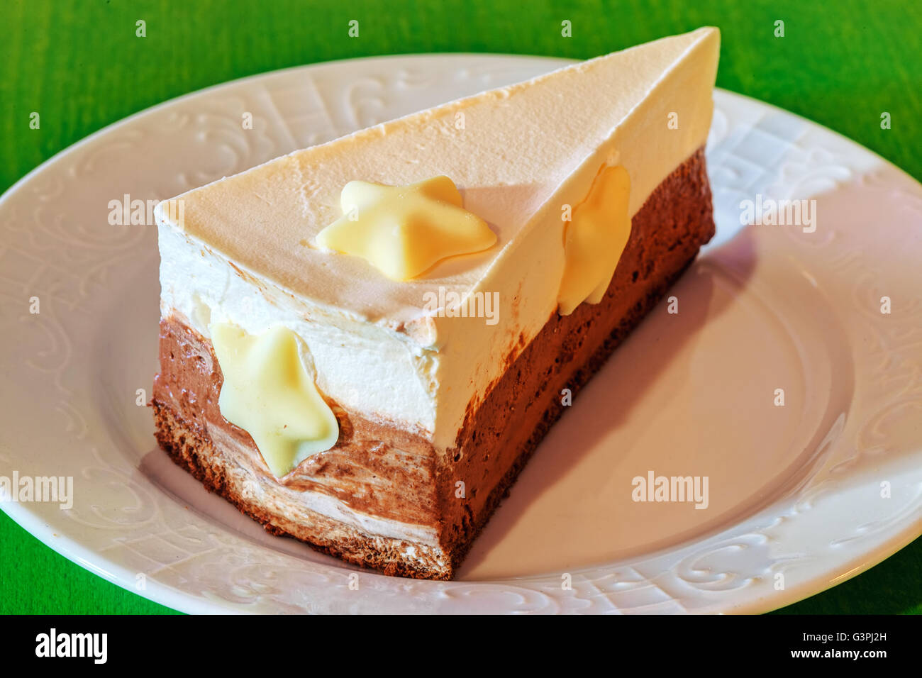 Delicious cake slice on plate on table at small pastry shop Stock Photo ...