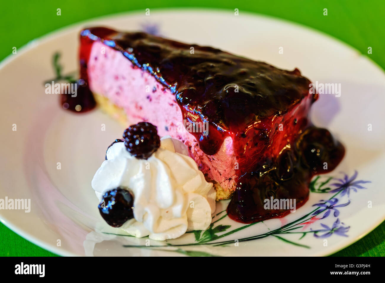 Delicious cake slice on plate on table at small pastry shop Stock Photo ...