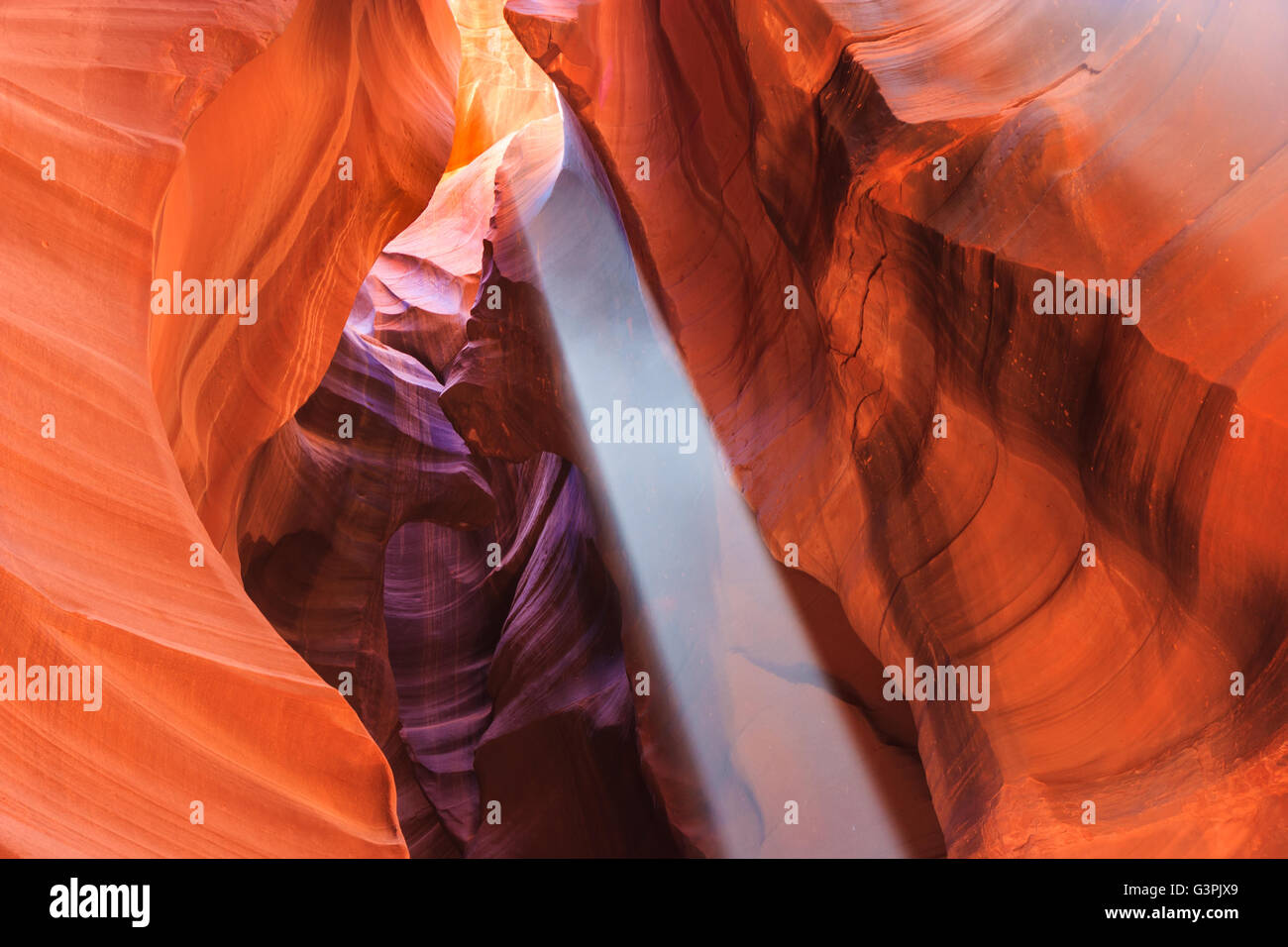 Beam of sun ray and dust between colorful sandstone walls of Upper and ...