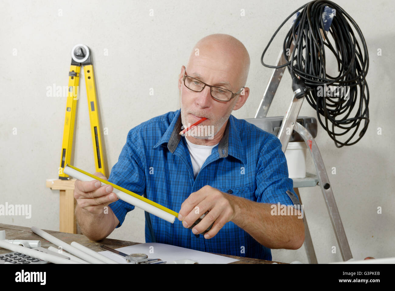 a portrait of mature handyman at DIY workshop Stock Photo - Alamy