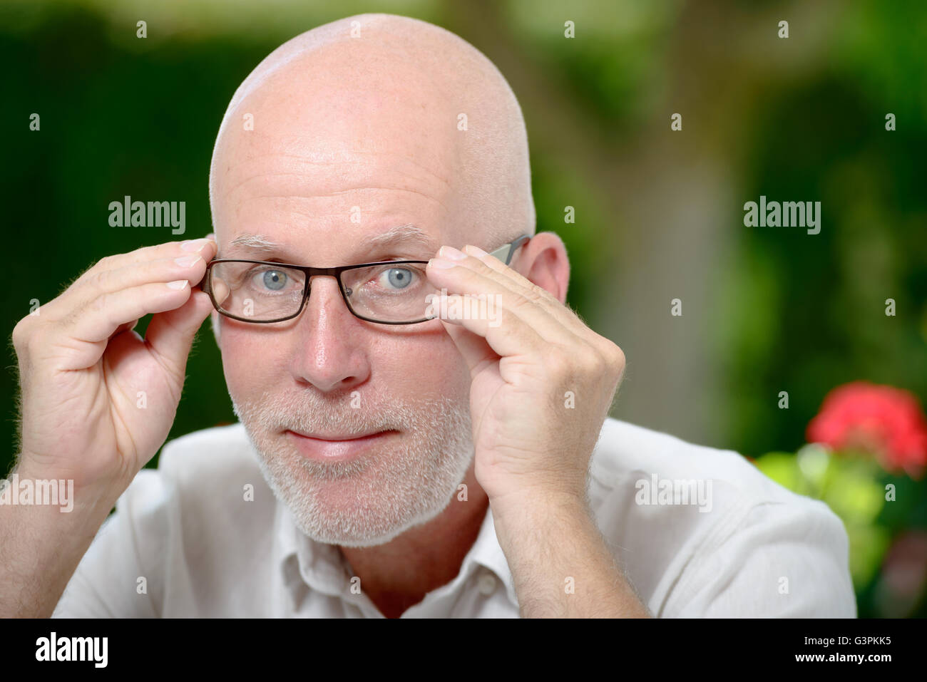 a portrait of a mature man with glasses near a window Stock Photo - Alamy