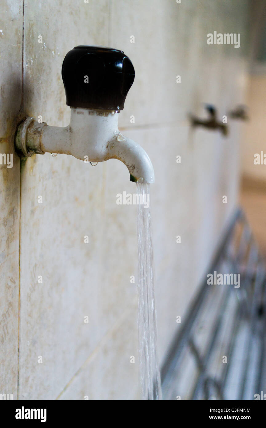 Plastic Mosque Water Tap on Ceramic Wall Stock Photo - Alamy