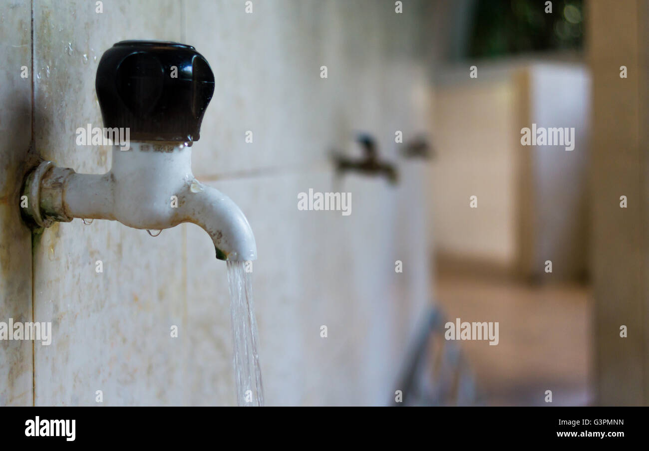 Plastic Mosque Water Tap on Ceramic Wall Stock Photo - Alamy