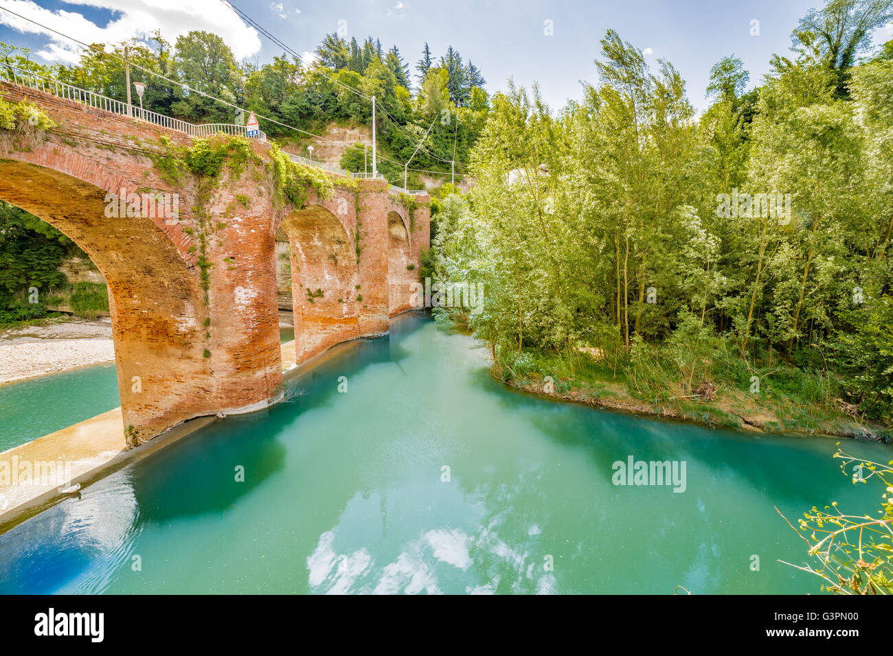 fourteenth century bridge in masonry over the River in a small village ...