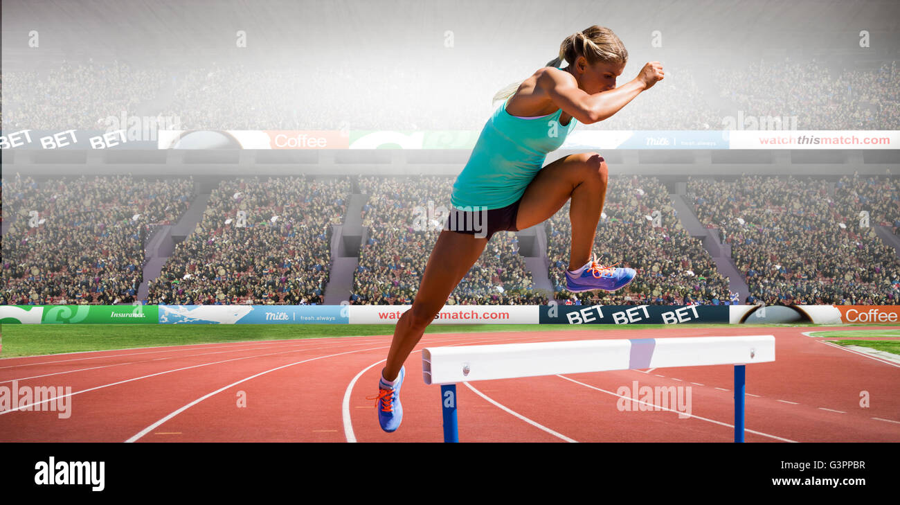 Composite image of athlete woman jumping a hurdle Stock Photo - Alamy