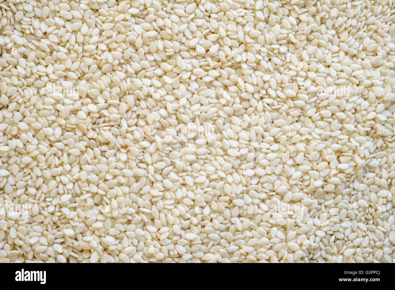 Background of white raw sesame seeds, top view Stock Photo - Alamy