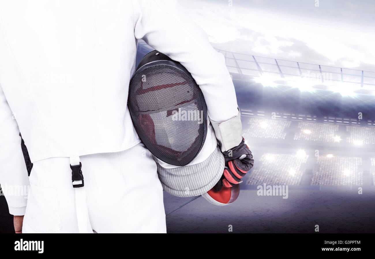 Composite image of rear view of swordsman holding fencing mask and ...