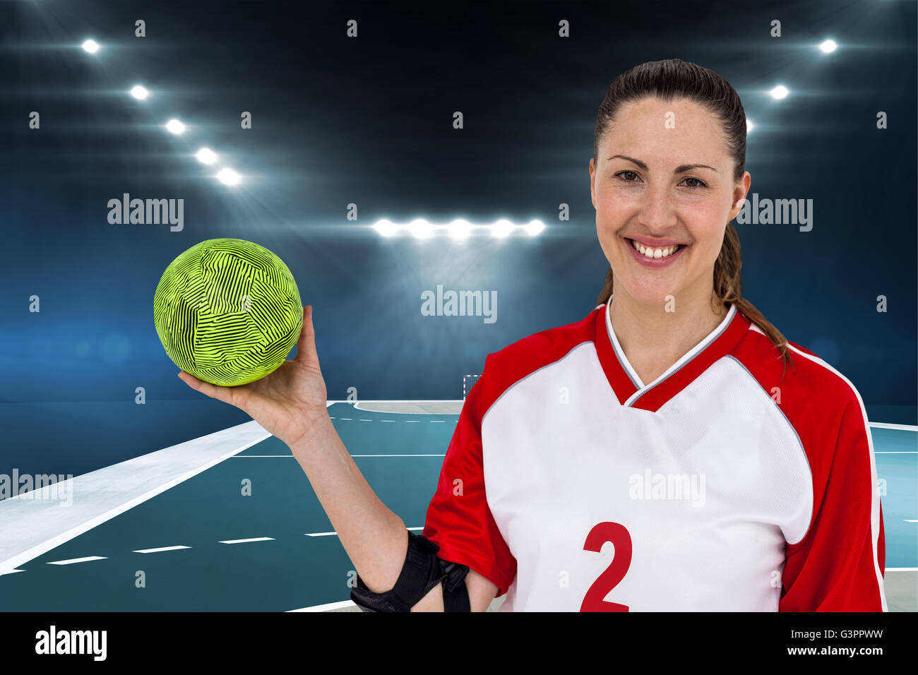 Composite image of sportswoman posing with ball Stock Photo - Alamy