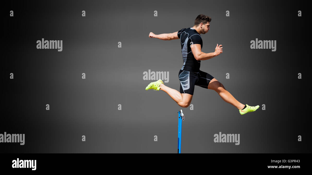 Athletic man practicing show jumping Stock Photo - Alamy