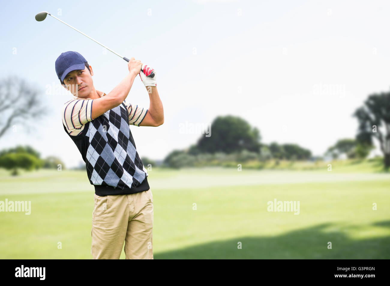 Man playing golf against nature scene Stock Photo - Alamy