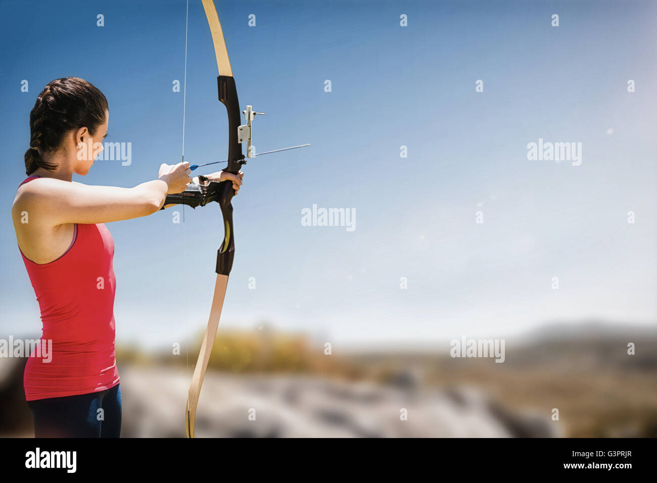Composite image of side view of woman practicing archery Stock Photo - Alamy