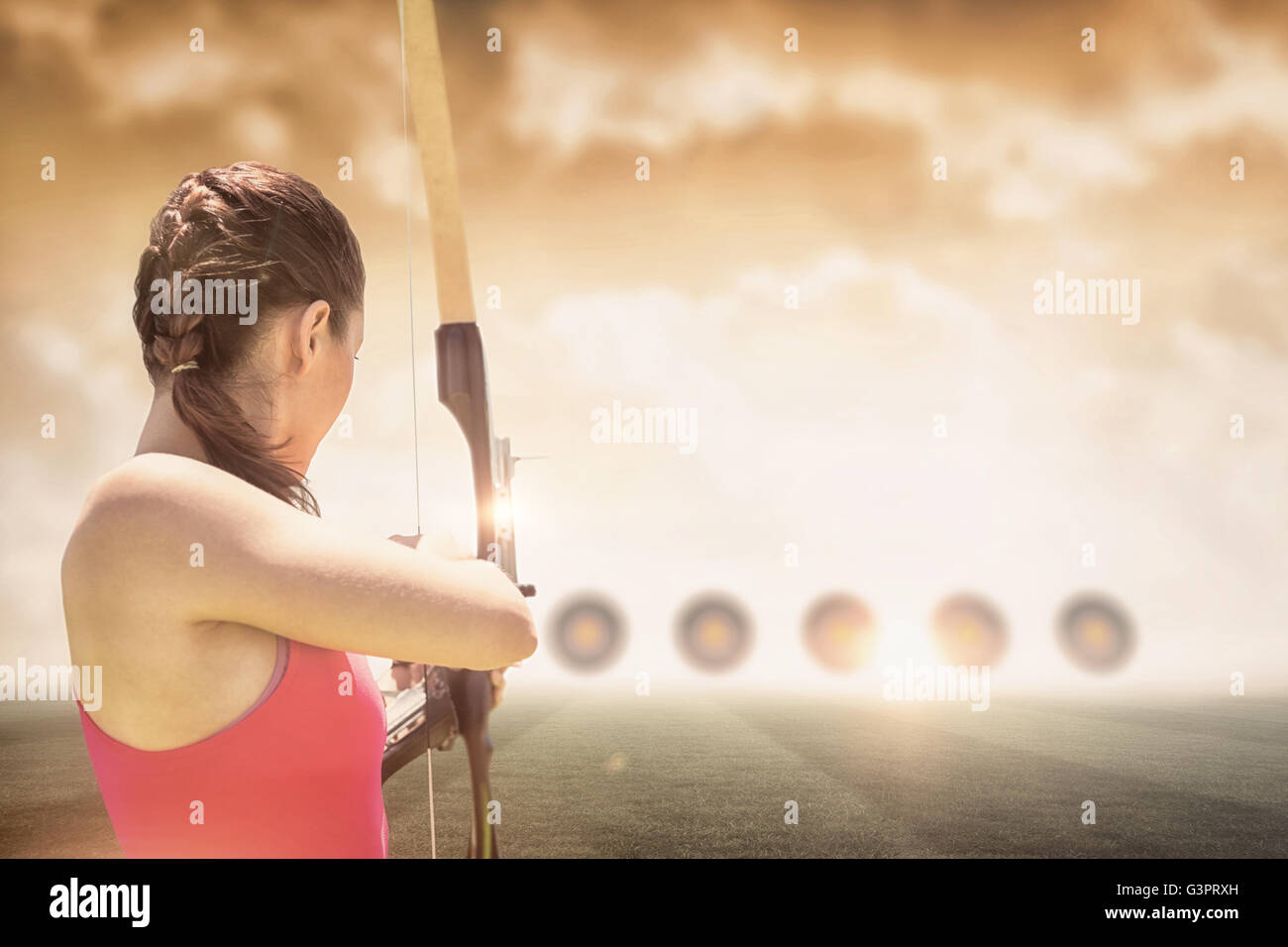 Rear view of sportswoman doing archery Stock Photo - Alamy