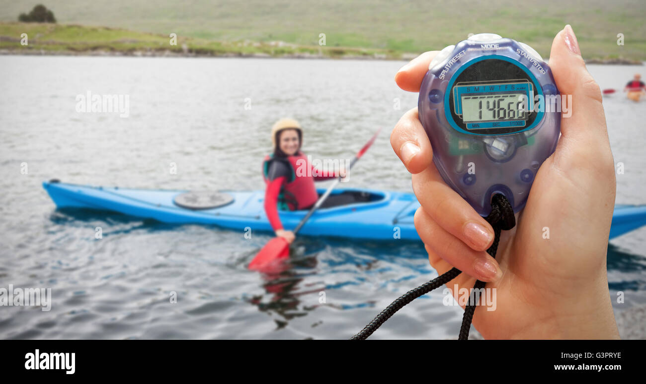 Composite image of a hand holding a timer Stock Photo - Alamy
