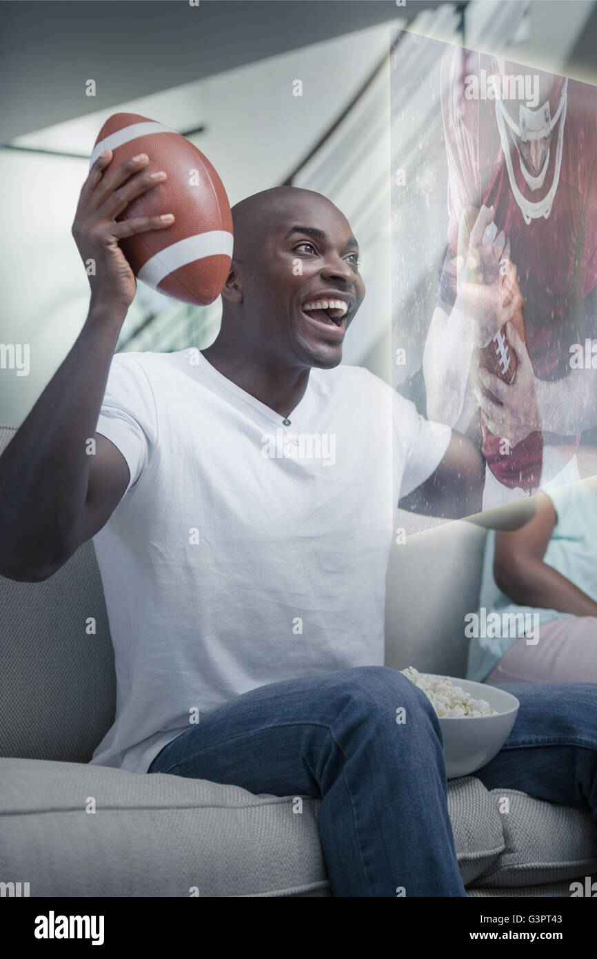 Composite image of happy man is watching sport on television Stock ...