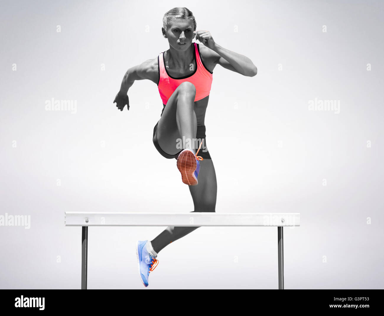 Athletic woman practicing show jumping Stock Photo - Alamy