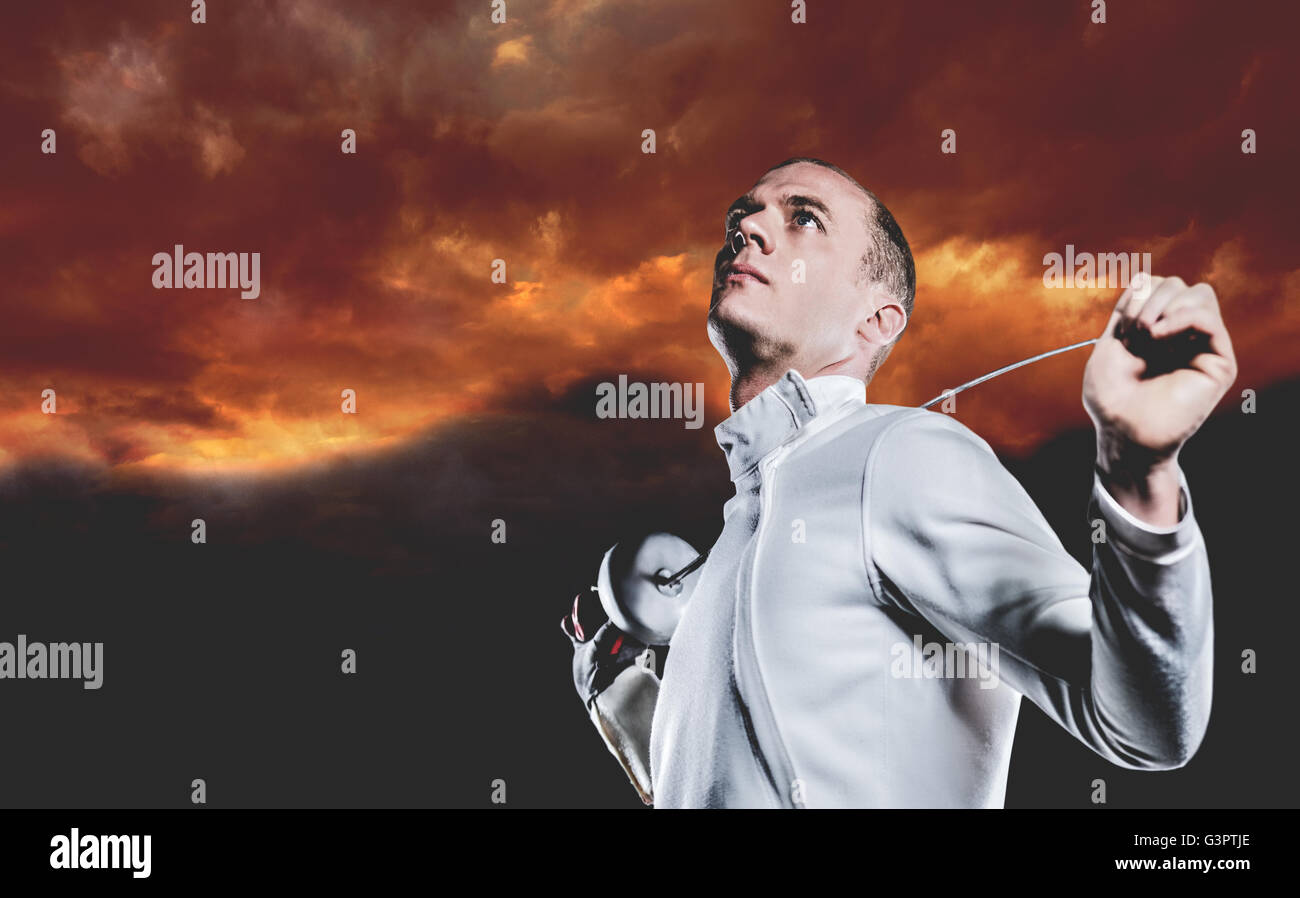 Composite image of swordsman holding fencing sword Stock Photo - Alamy