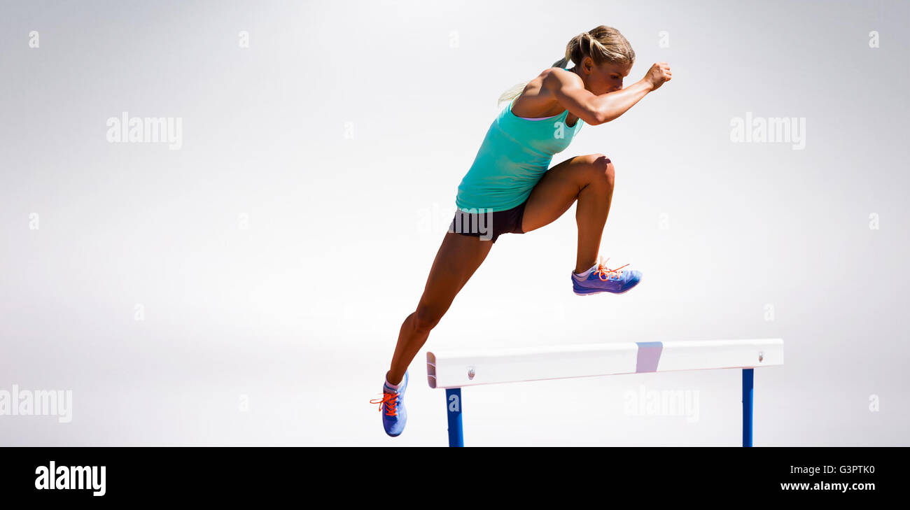 Young female athlete hurdling hi-res stock photography and images - Alamy