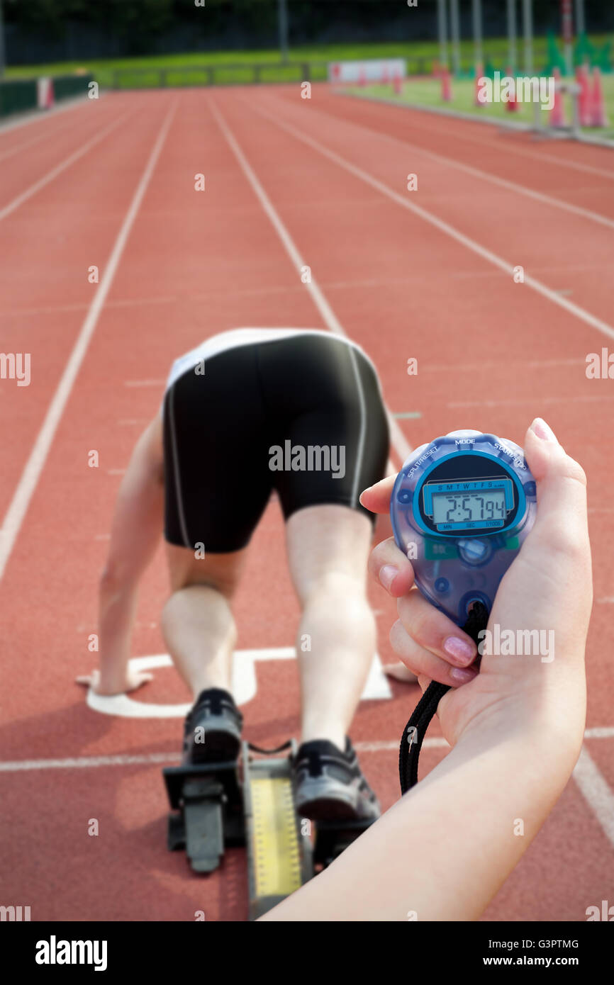 Close-up of a woman holding a chronometer to measure performance ...