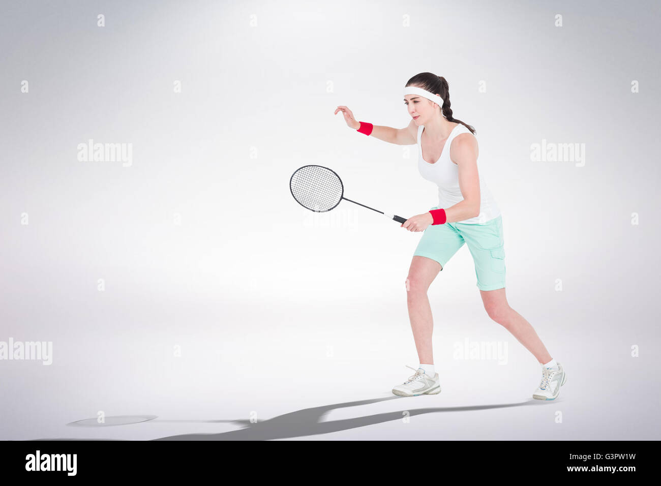 Composite image of female athlete playing badminton Stock Photo - Alamy