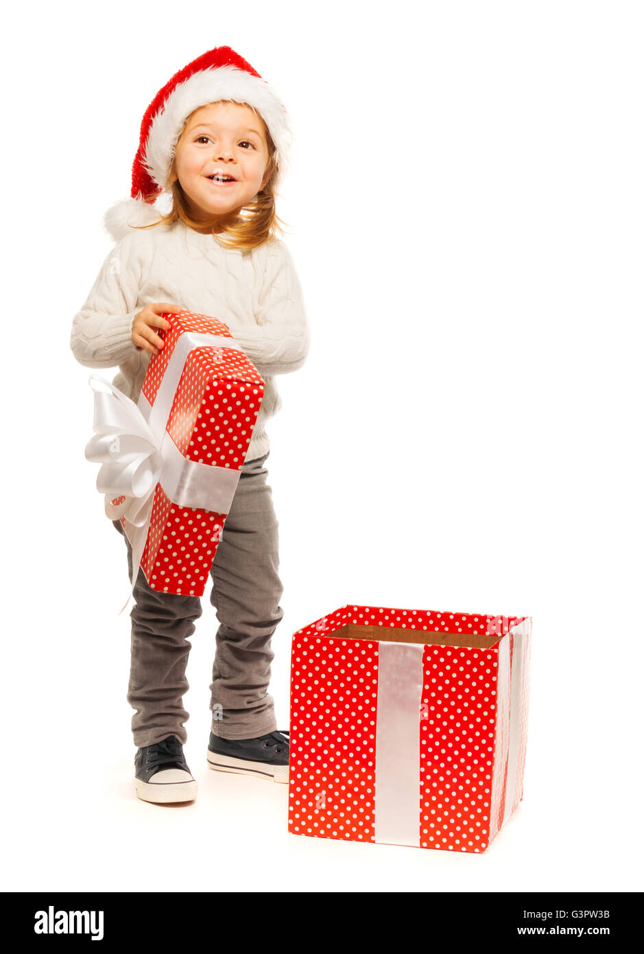 Surprised little girl opening her present Stock Photo - Alamy