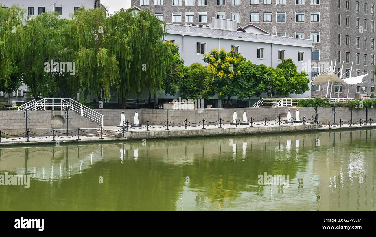 Waterside terrace with recreation area and green trees, riverside deck ...
