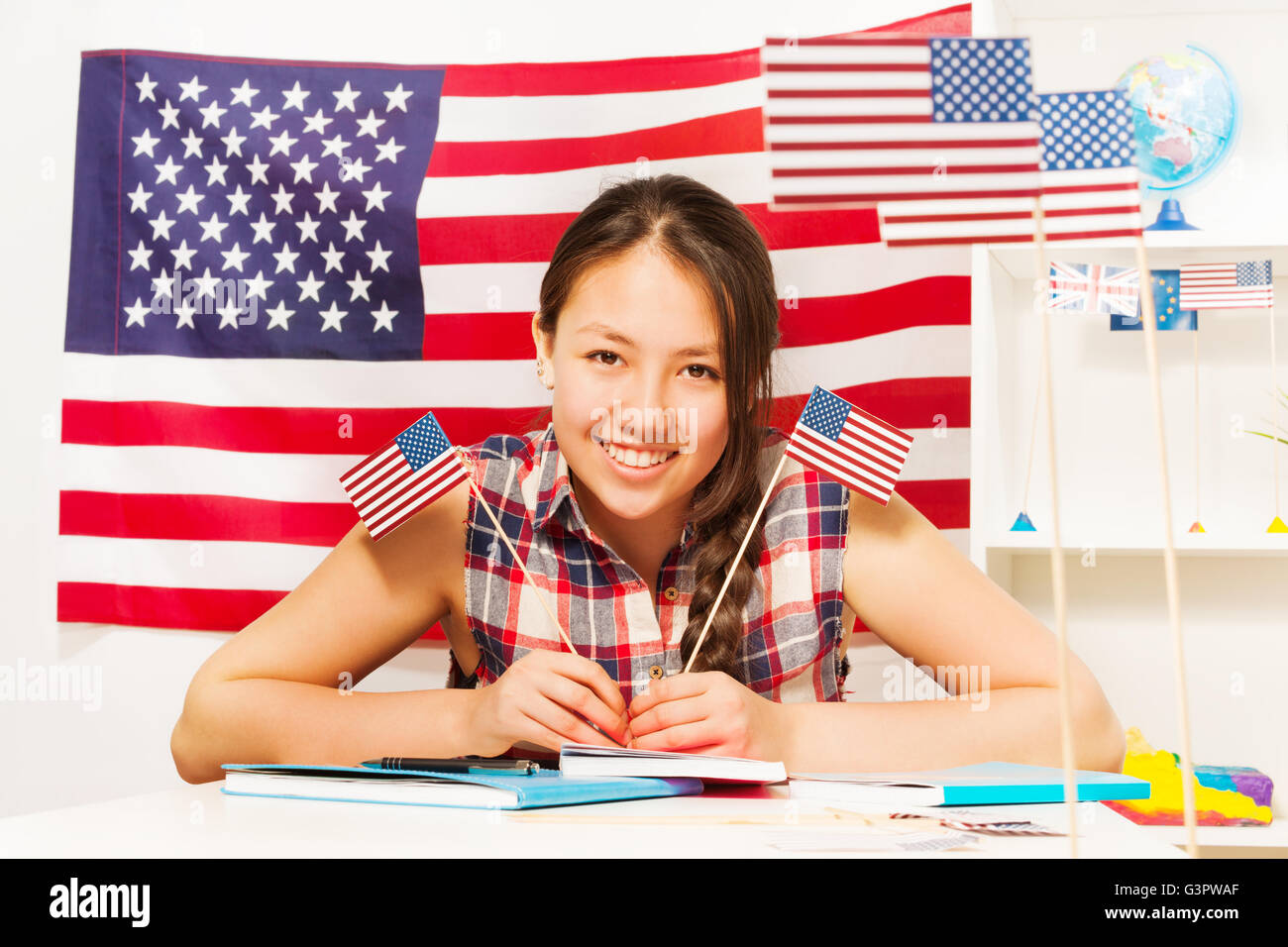Teenage female student with two flags of USA Stock Photo - Alamy