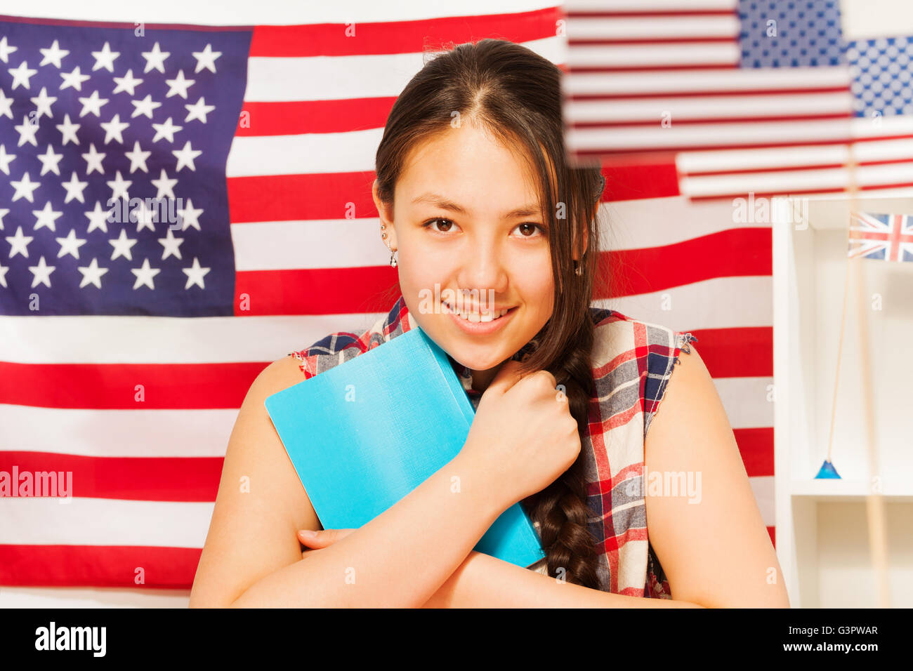Pretty teenage girl with books studying English Stock Photo - Alamy