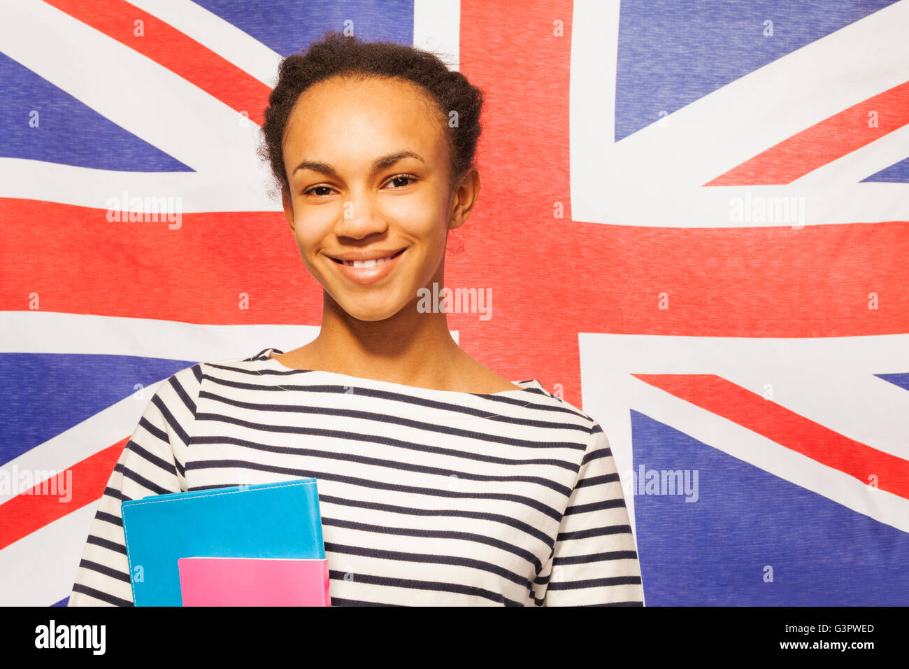 Smiling English student with textbooks Stock Photo - Alamy