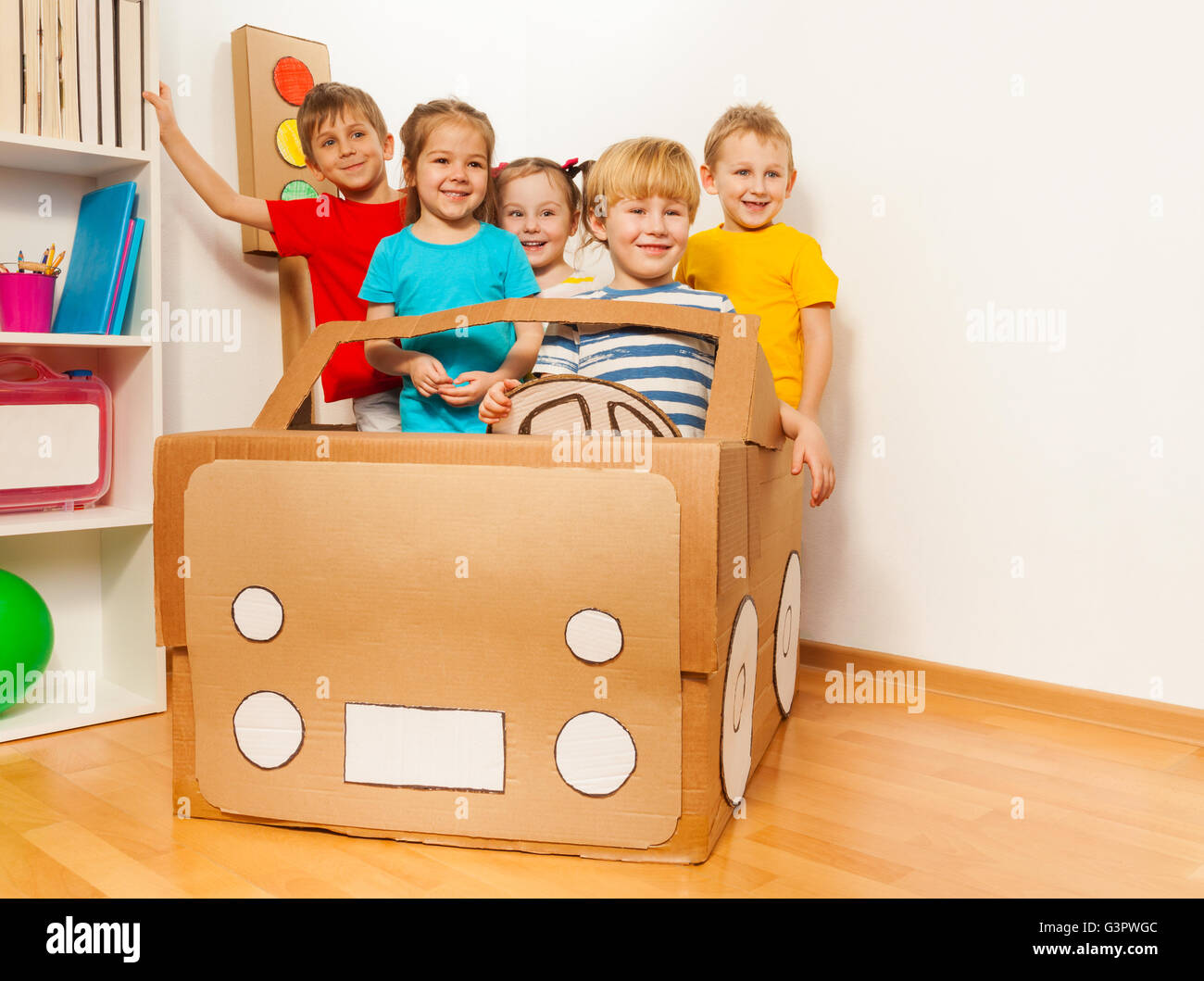 Five smiling kids driving handmade cardboard car Stock Photo - Alamy