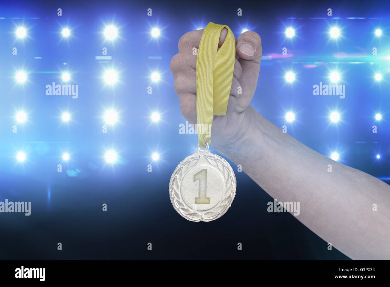 Composite image of athlete holding gold medal after victory Stock Photo ...