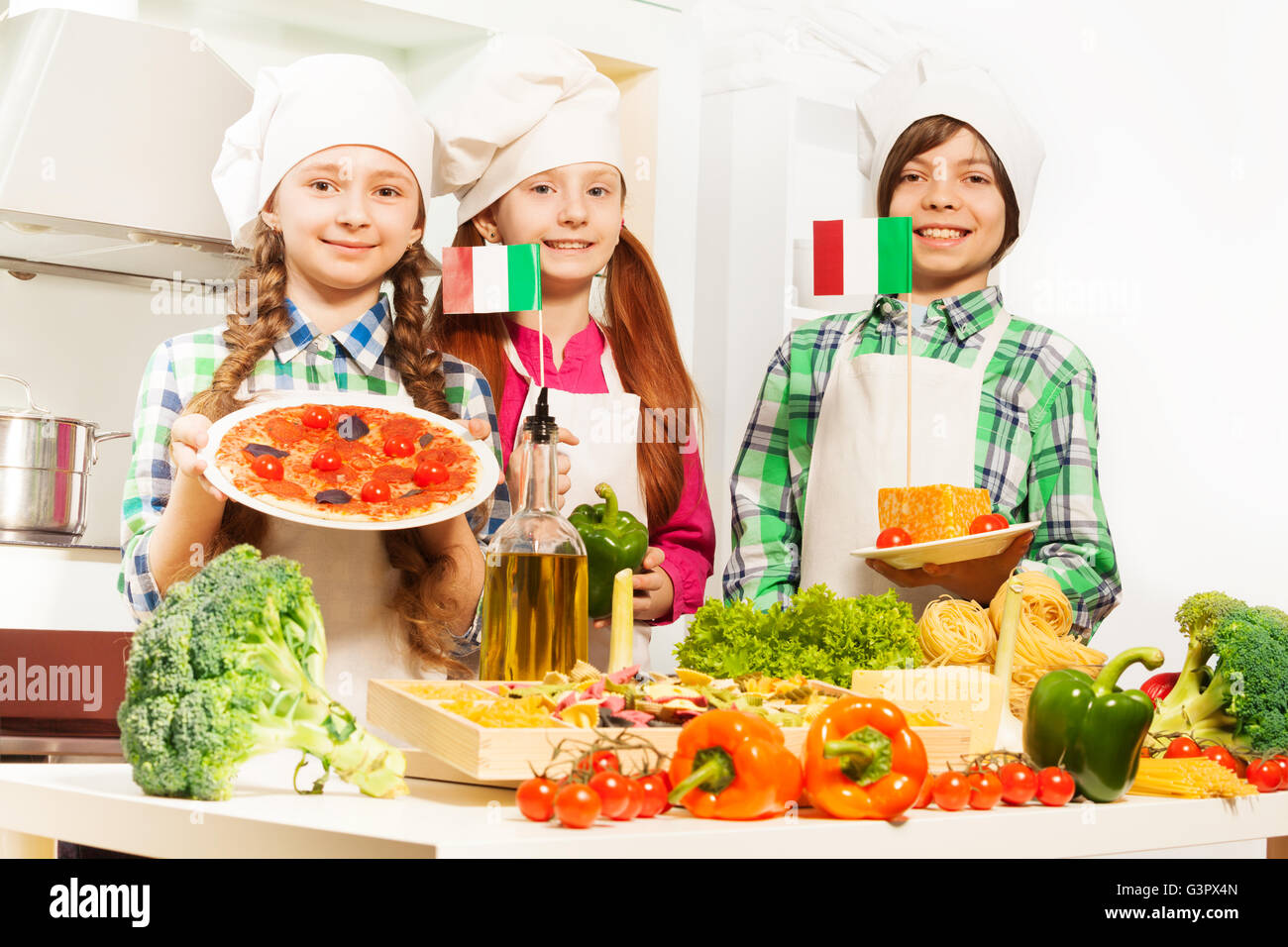 Three cooks with traditional Italian food products Stock Photo - Alamy