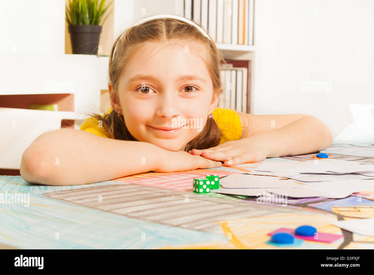 Cute smiling girl sitting at the gaming table Stock Photo - Alamy