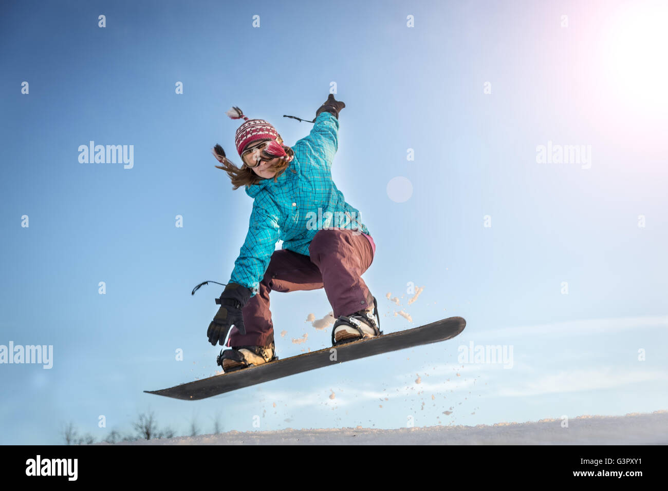 Young woman on the snowboard jumping Stock Photo - Alamy