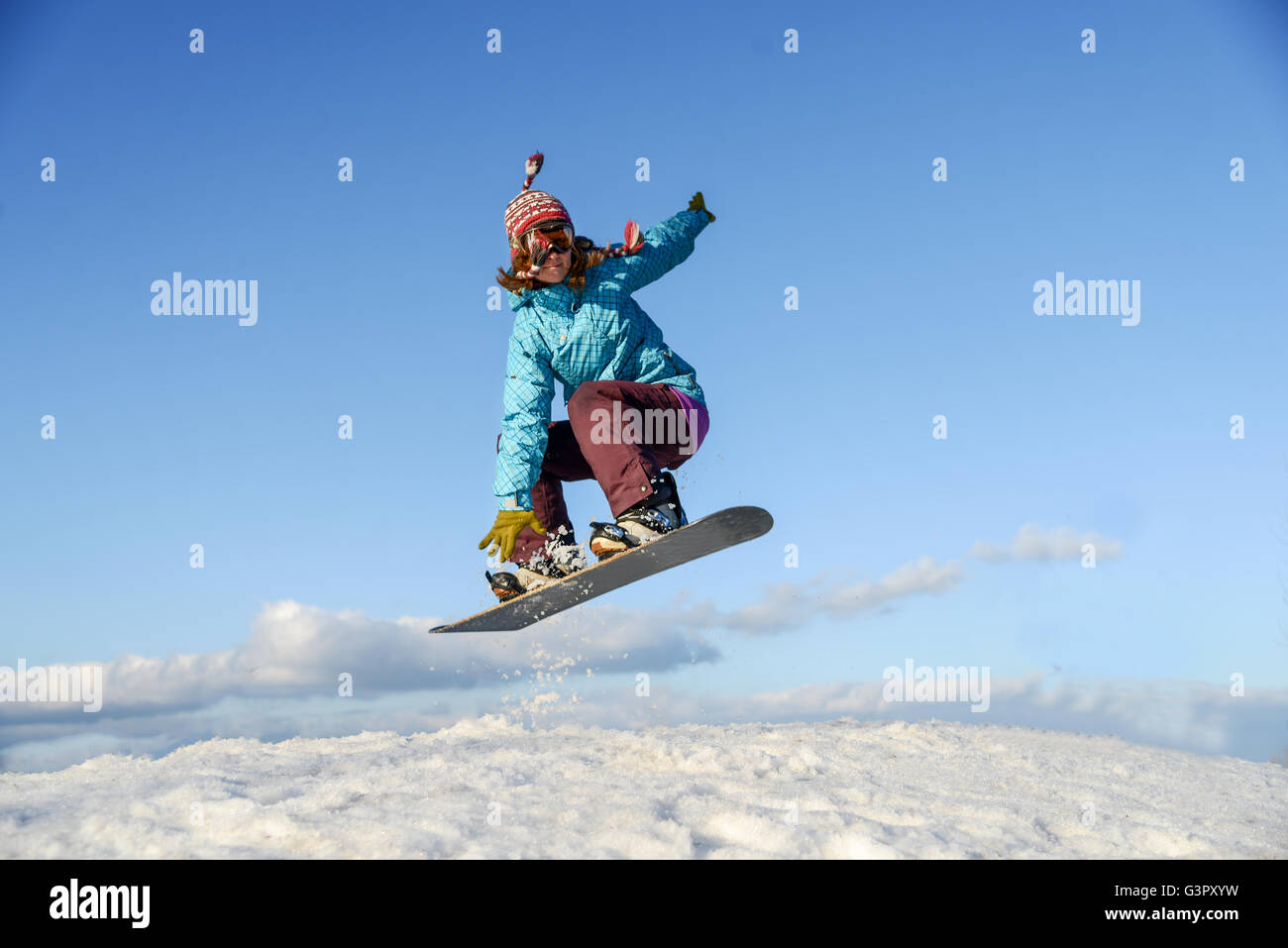 Young woman on the snowboard jumping Stock Photo - Alamy