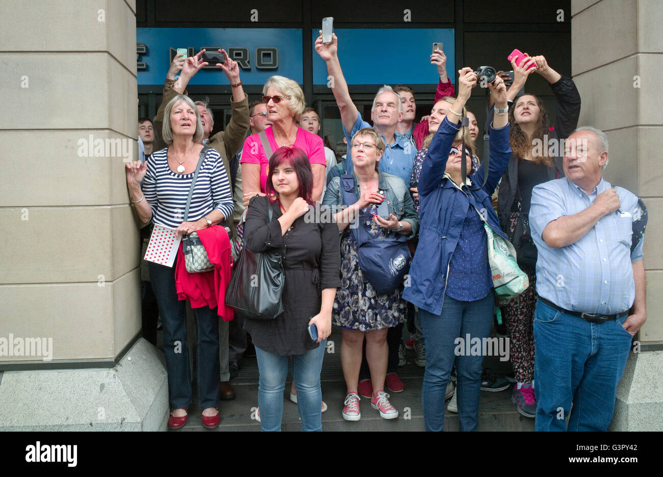 A group of Tourists with their camera phones and digital cameras taking ...
