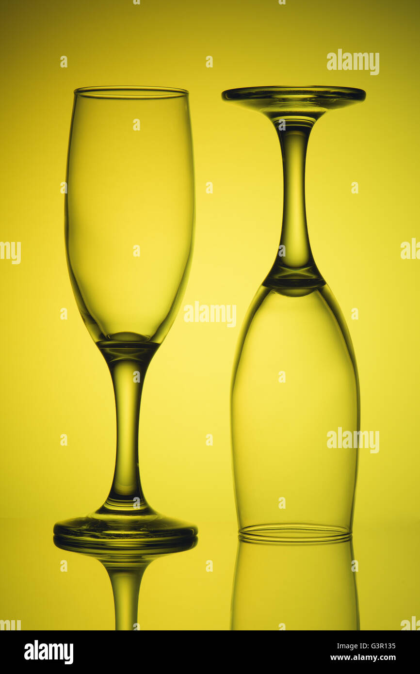 Two empty glasses in yellow light Stock Photo - Alamy