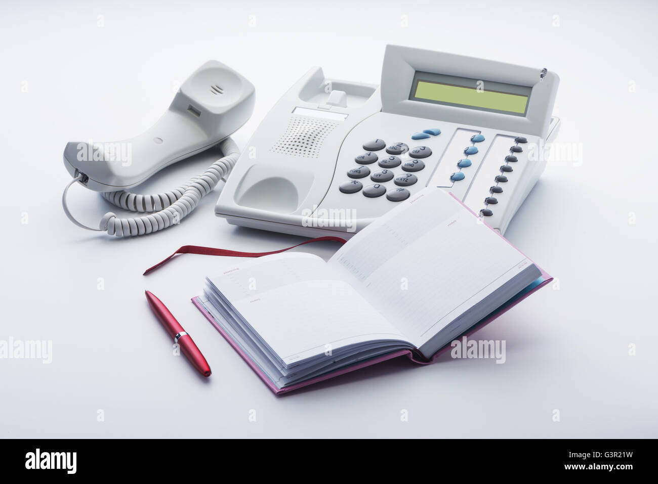The telephone set, notepad and pen on a white background Stock Photo ...